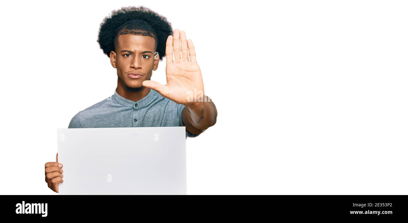 African american man with afro hair holding blank empty banner with ...