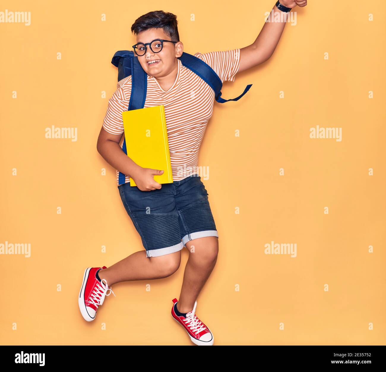 Adorable student boy wearing glasses and backpack smiling happy ...