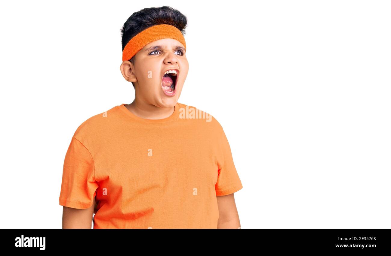 Little boy kid wearing sportswear angry and mad screaming frustrated ...