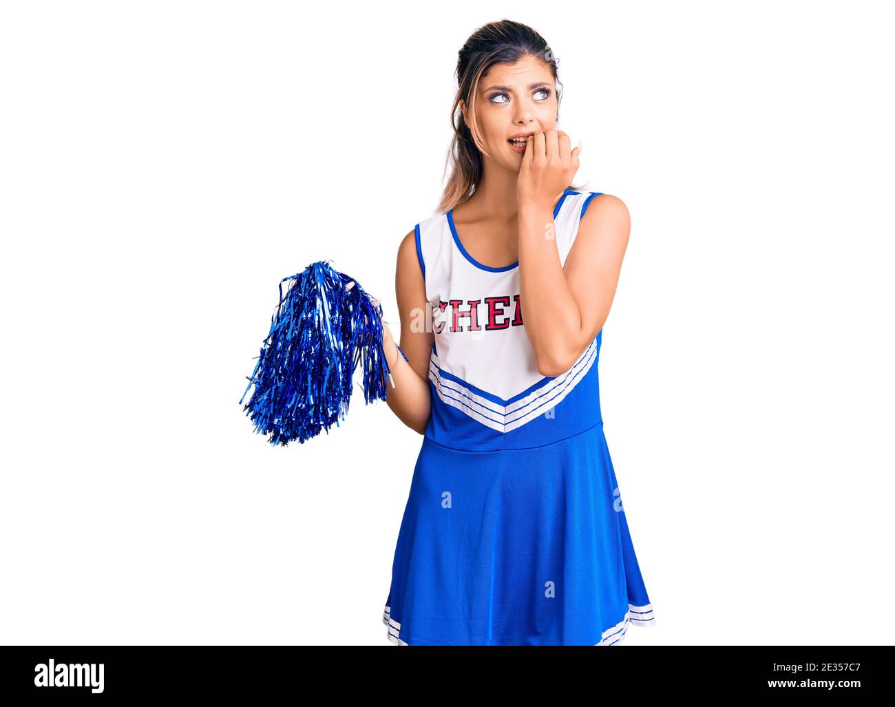 Young beautiful woman wearing cheerleader uniform looking stressed and ...