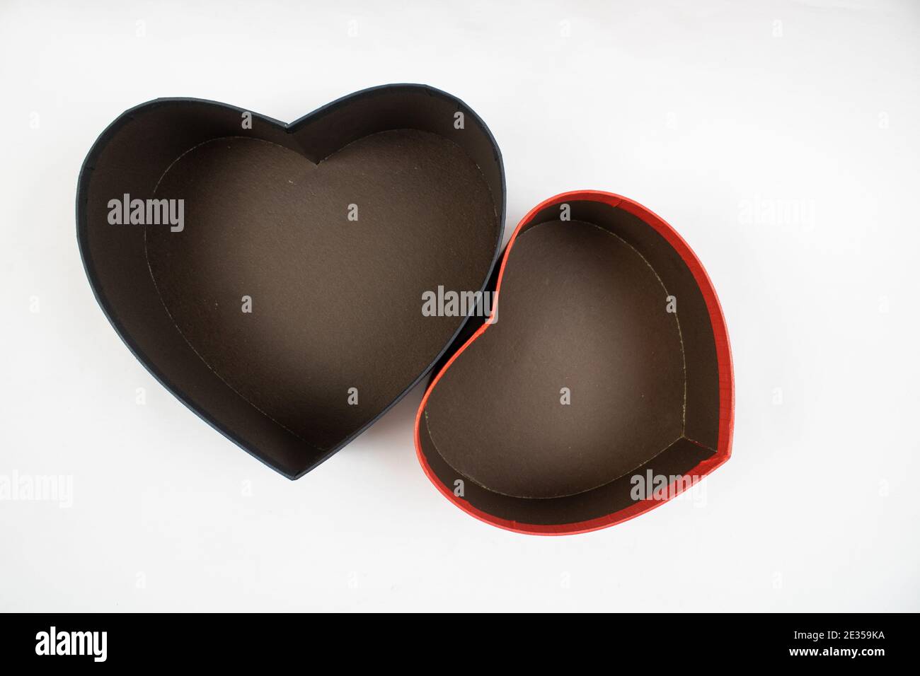 A top view shot of two open heart shaped gift boxes on a bright surface ...