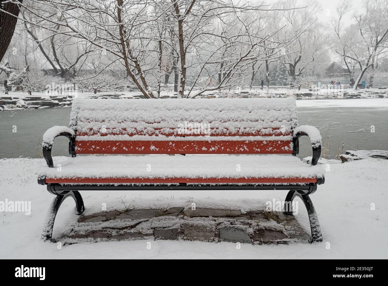 A snow-covered bench at the lakeside Stock Photo - Alamy
