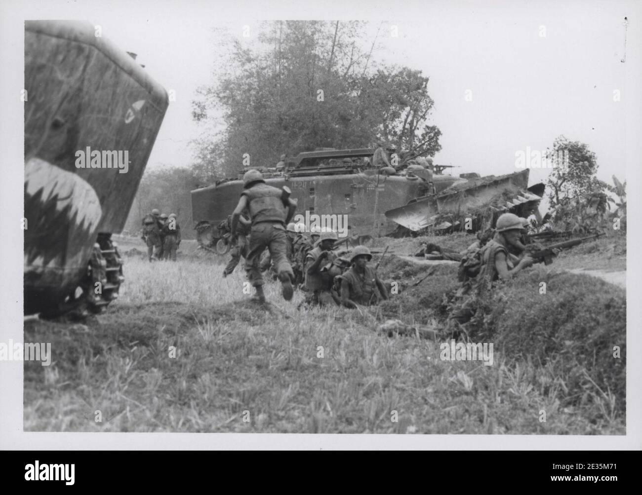 LVT-5s from the 1st Amtrac Battalion support 2.5 Marines following a ...