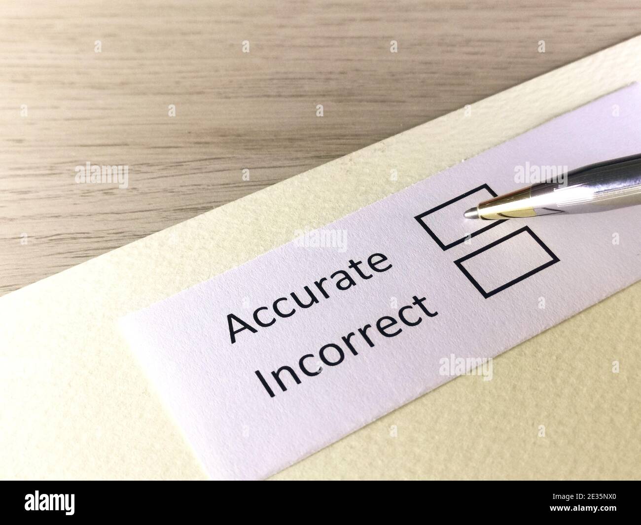 One person is answering question on a piece of paper. The person is ...