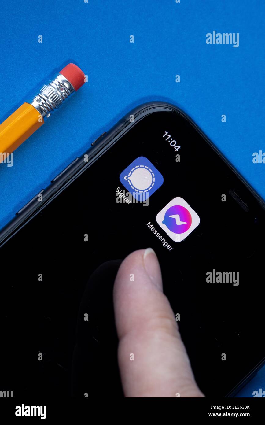 iPhone 11 on blue background with messengers apps Signal and facebook ...