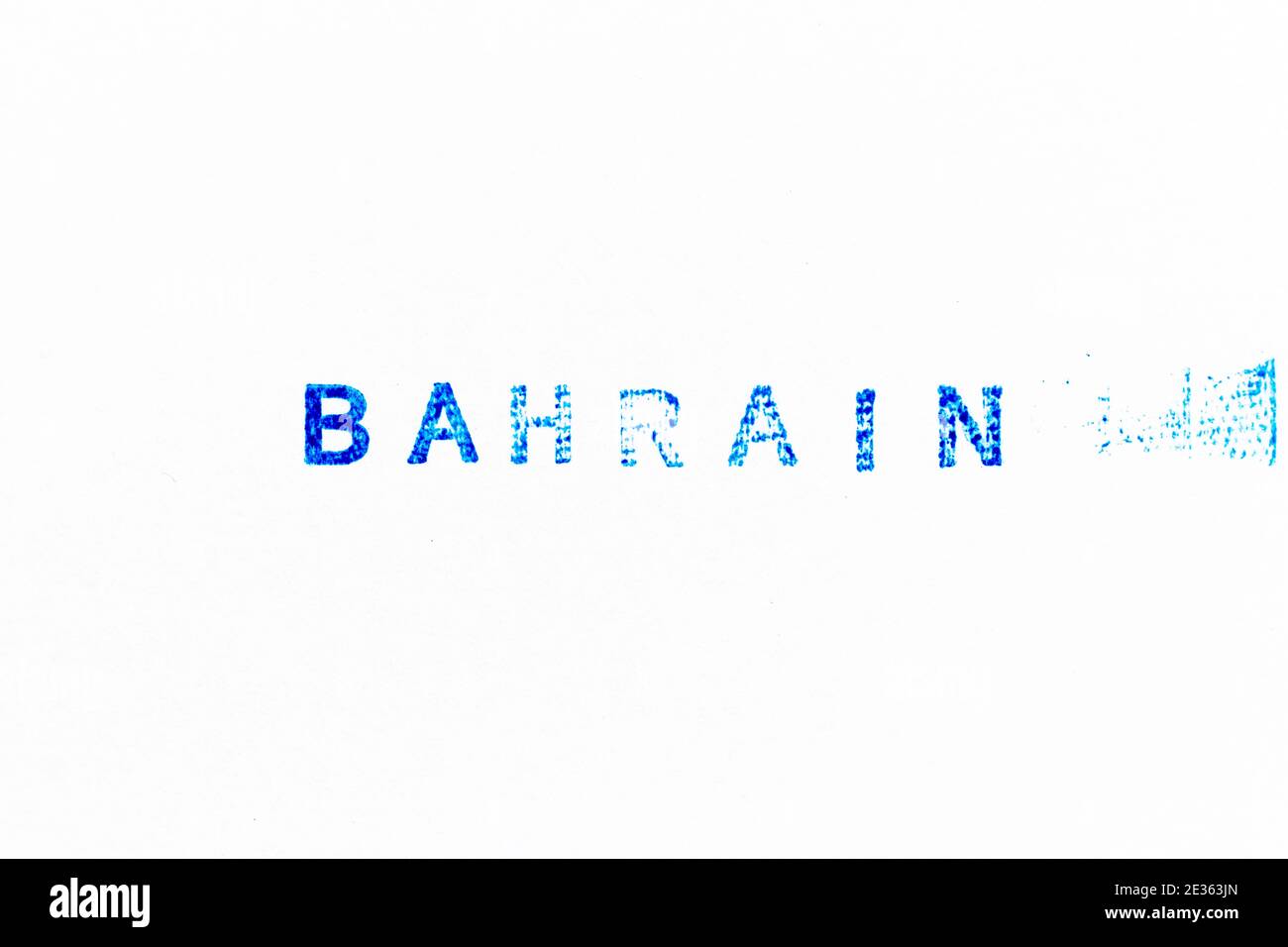 Blue color ink of rubber stamp in word bahrain on white paper ...