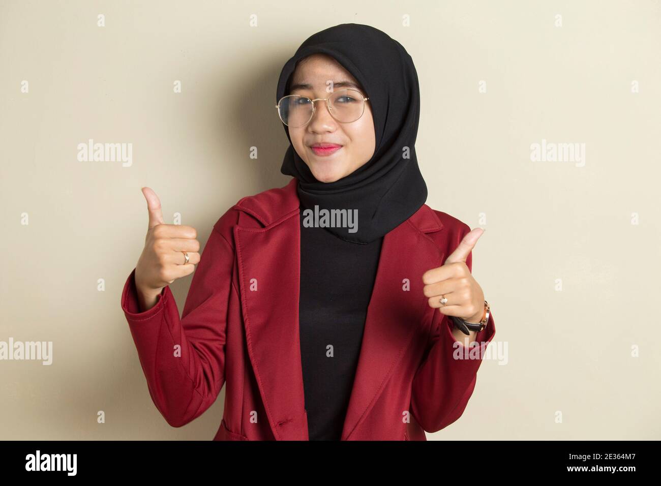 Asian muslim woman wearing glasses with ok sign gesture Stock Photo - Alamy