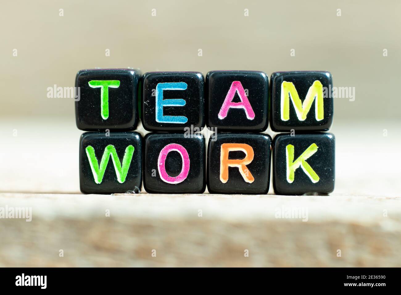 Black color block with word teamwork on wood background Stock Photo - Alamy