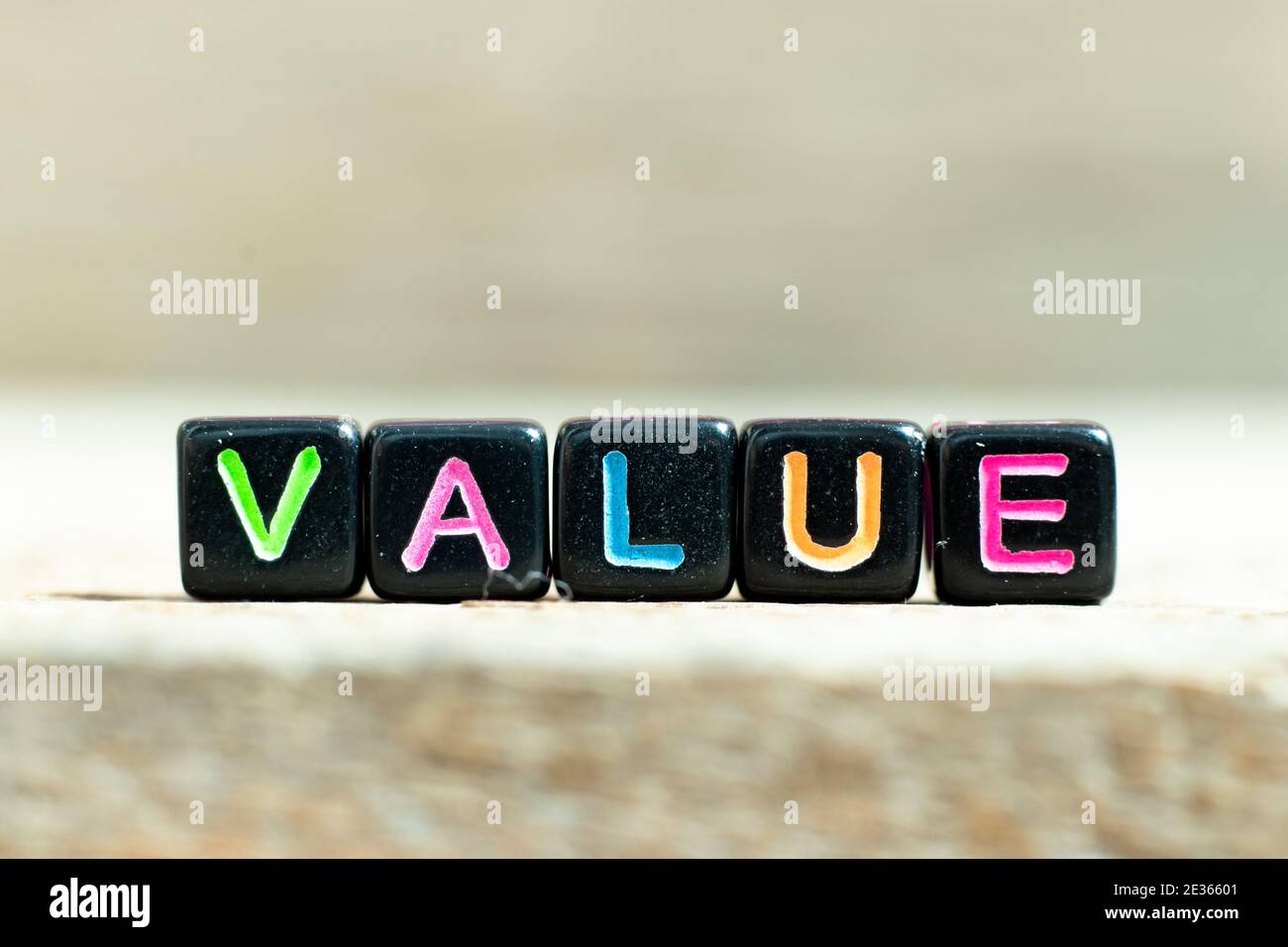 Black color block with word value on wood background Stock Photo - Alamy