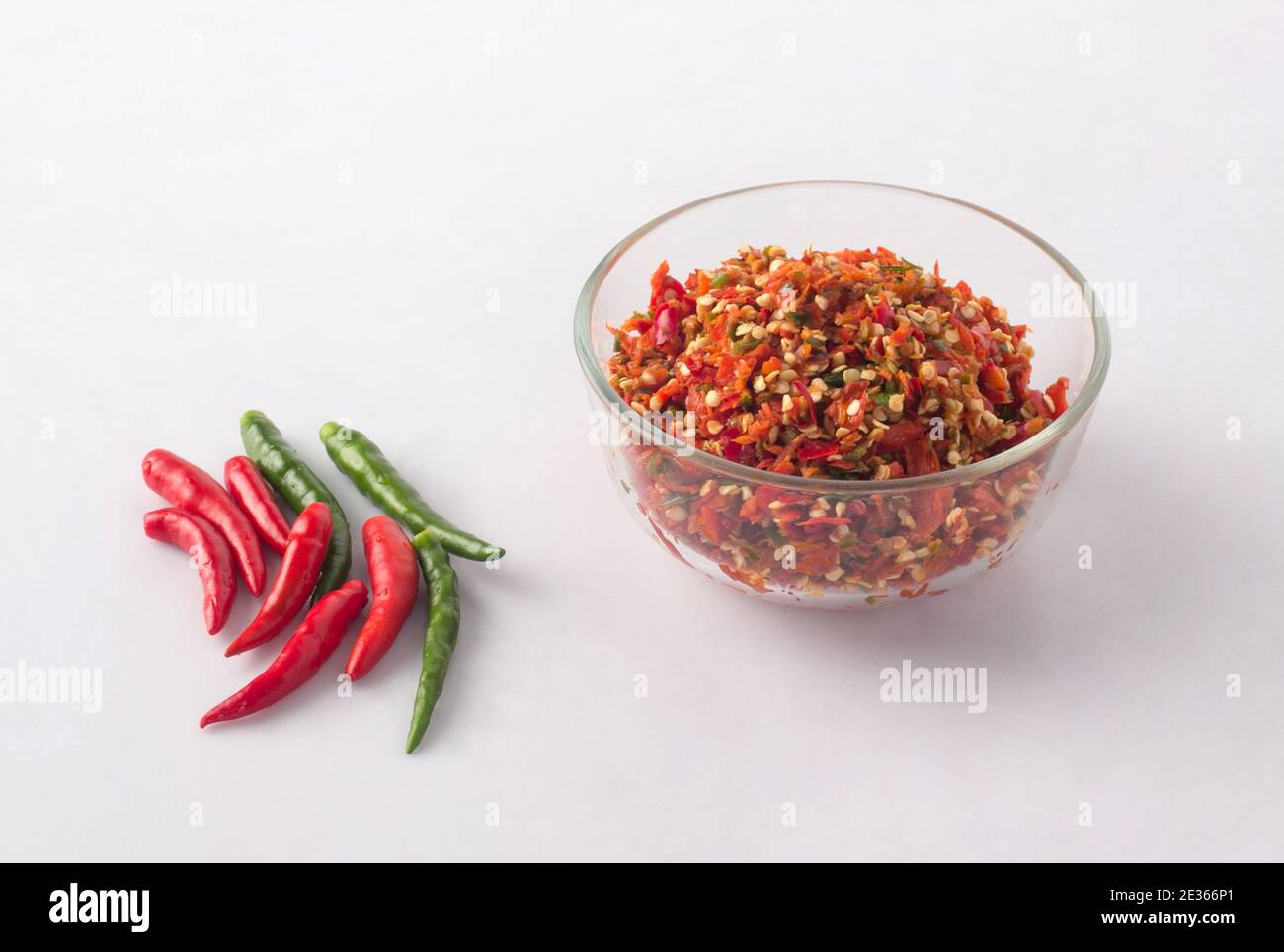 Chili and chopped chili in a glass bowl isolated on white background ...