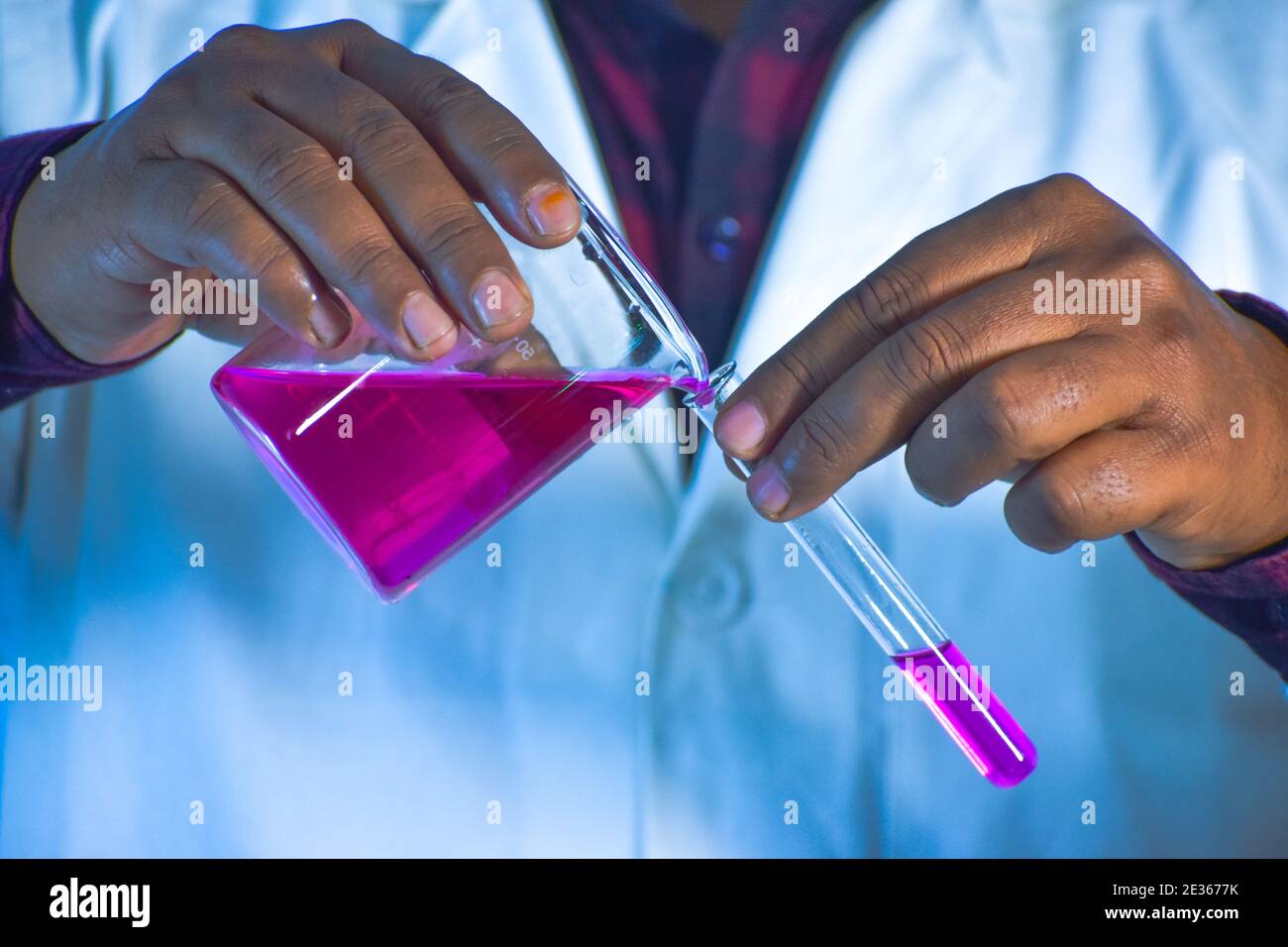 Scientist taking color solution in a test tube. Chemist with chemical ...