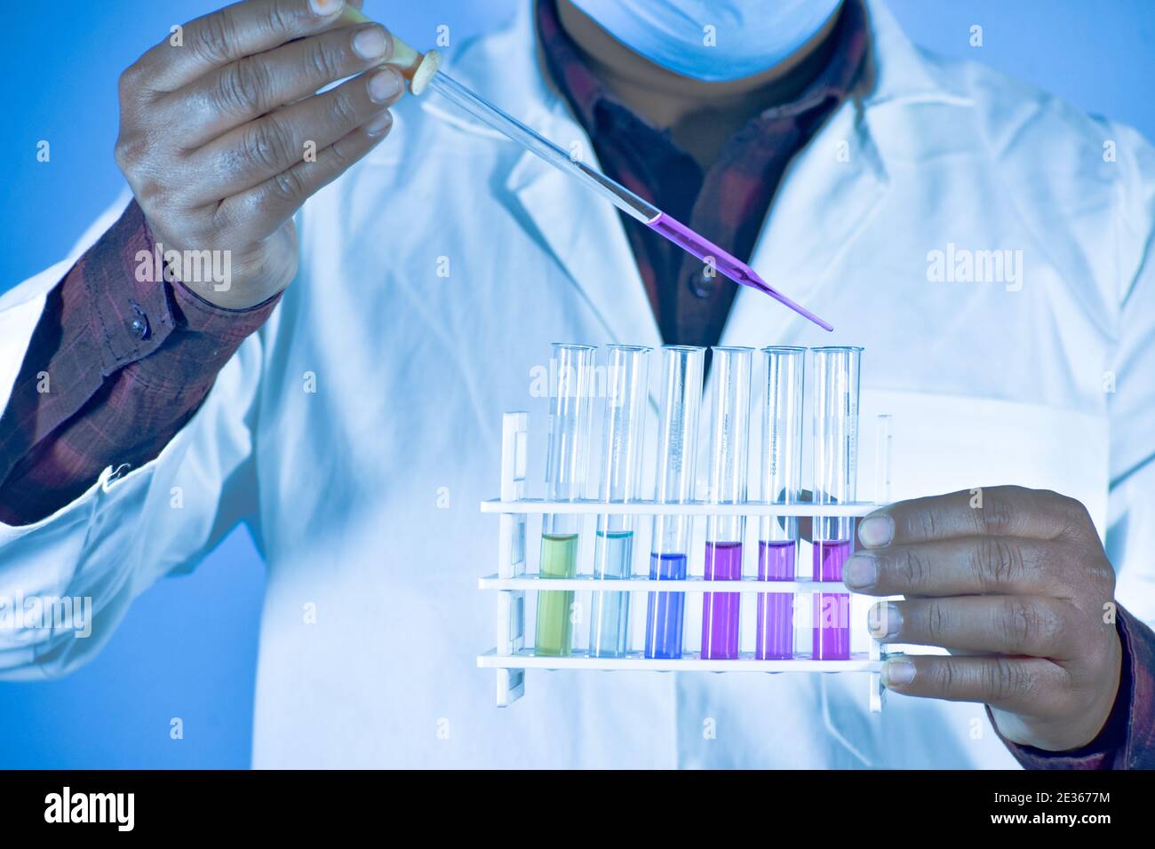 Test tube with color solution. Test tube in test tube stand. Scientist ...