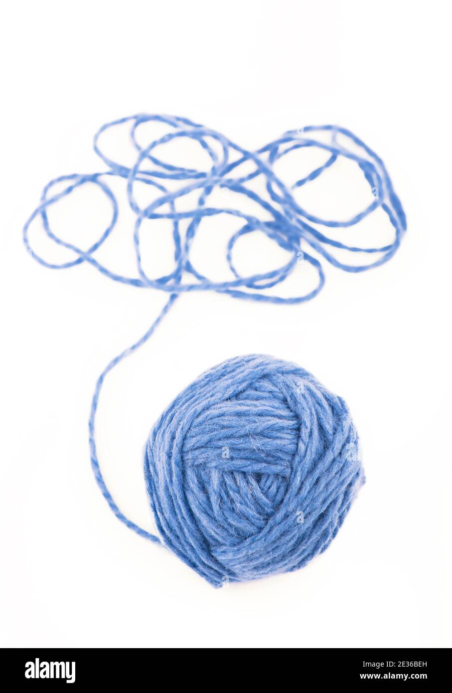 The idea is a tangled thread. Blue ball of yarn on white background ...