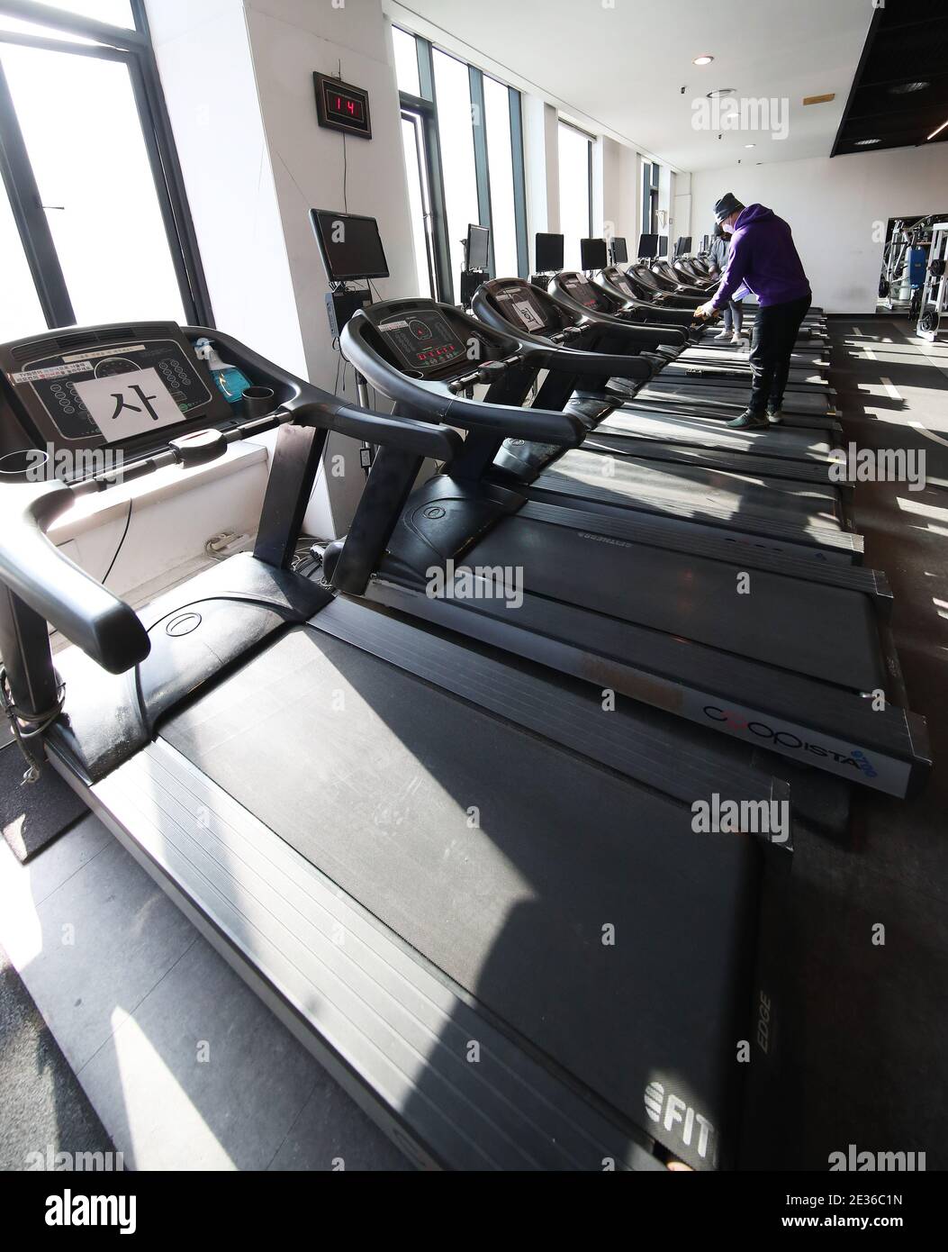 Eased COVID-19 ban on indoor gyms A staff member of a closed indoor gym ...