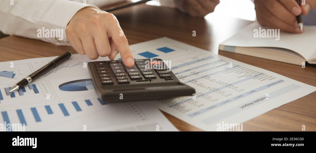 Banker using calculator hi-res stock photography and images - Alamy