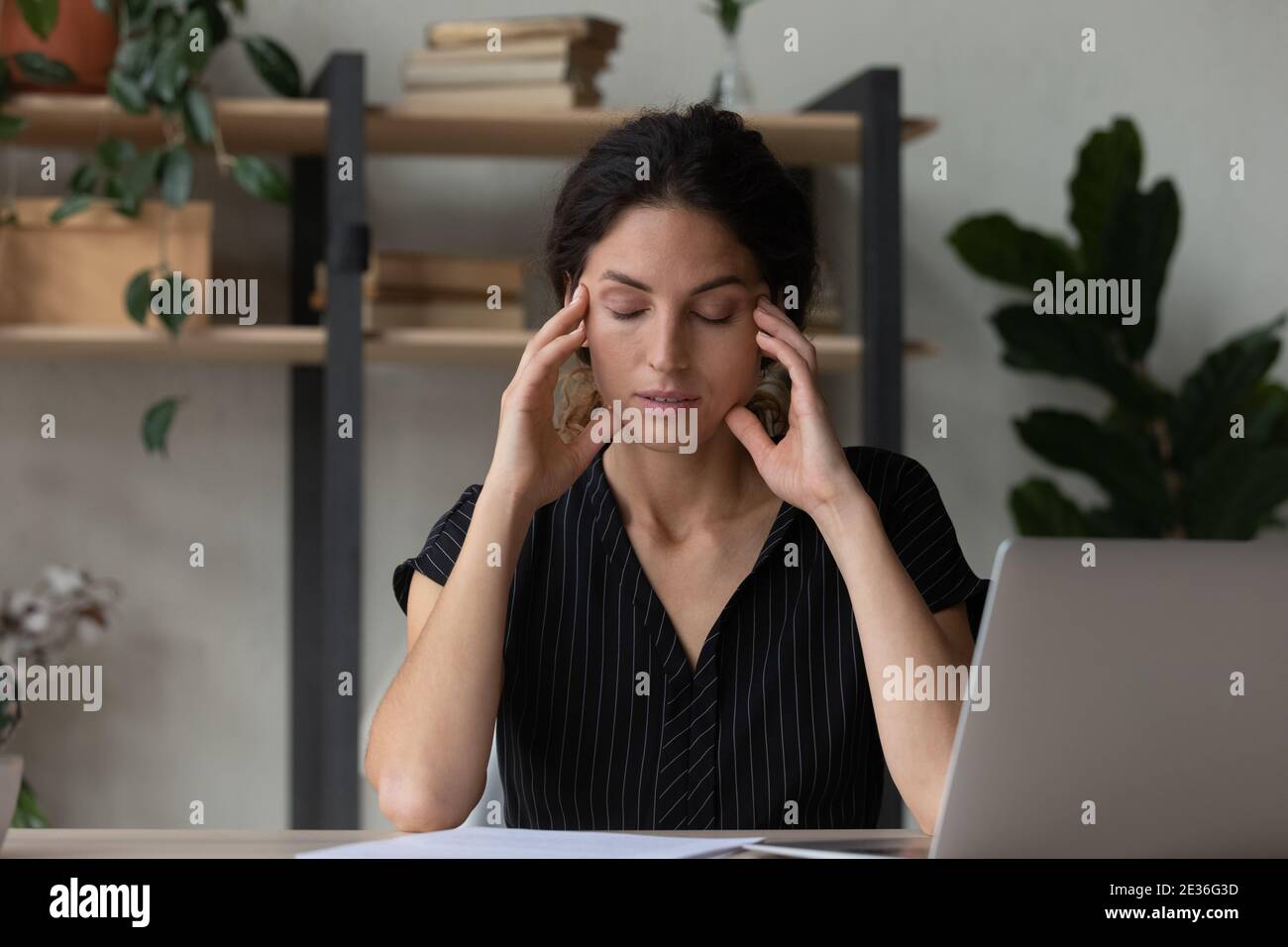 Tired young woman overwhelmed with computer work Stock Photo - Alamy