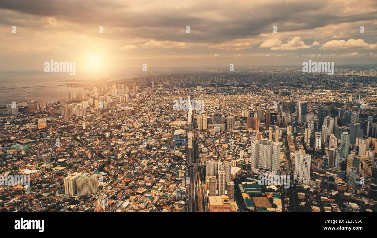 Sun cityscape of port town Manila aerial. Sunrise light over modern ...