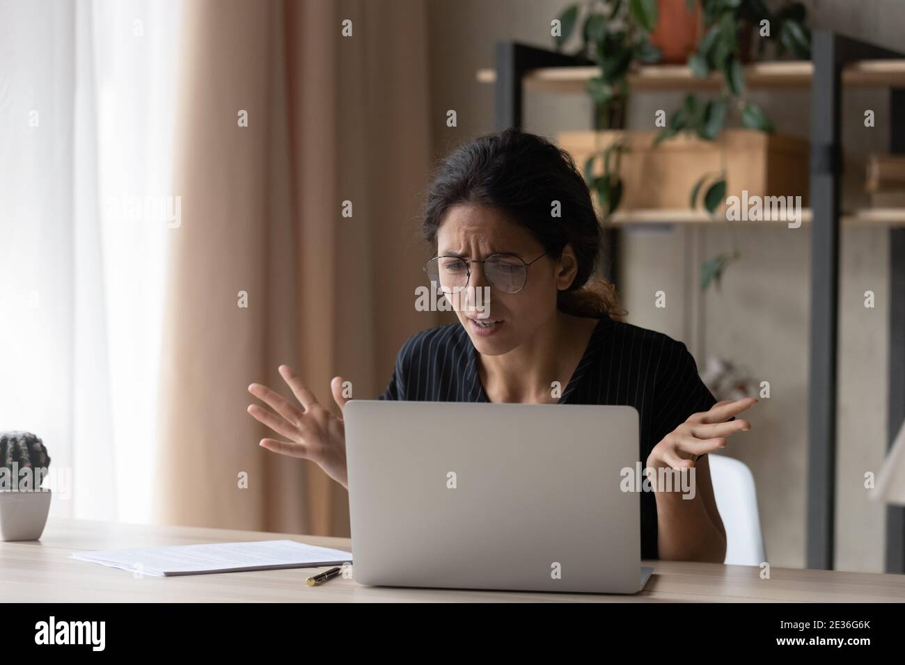 Upset young woman confused by laptop problems Stock Photo - Alamy