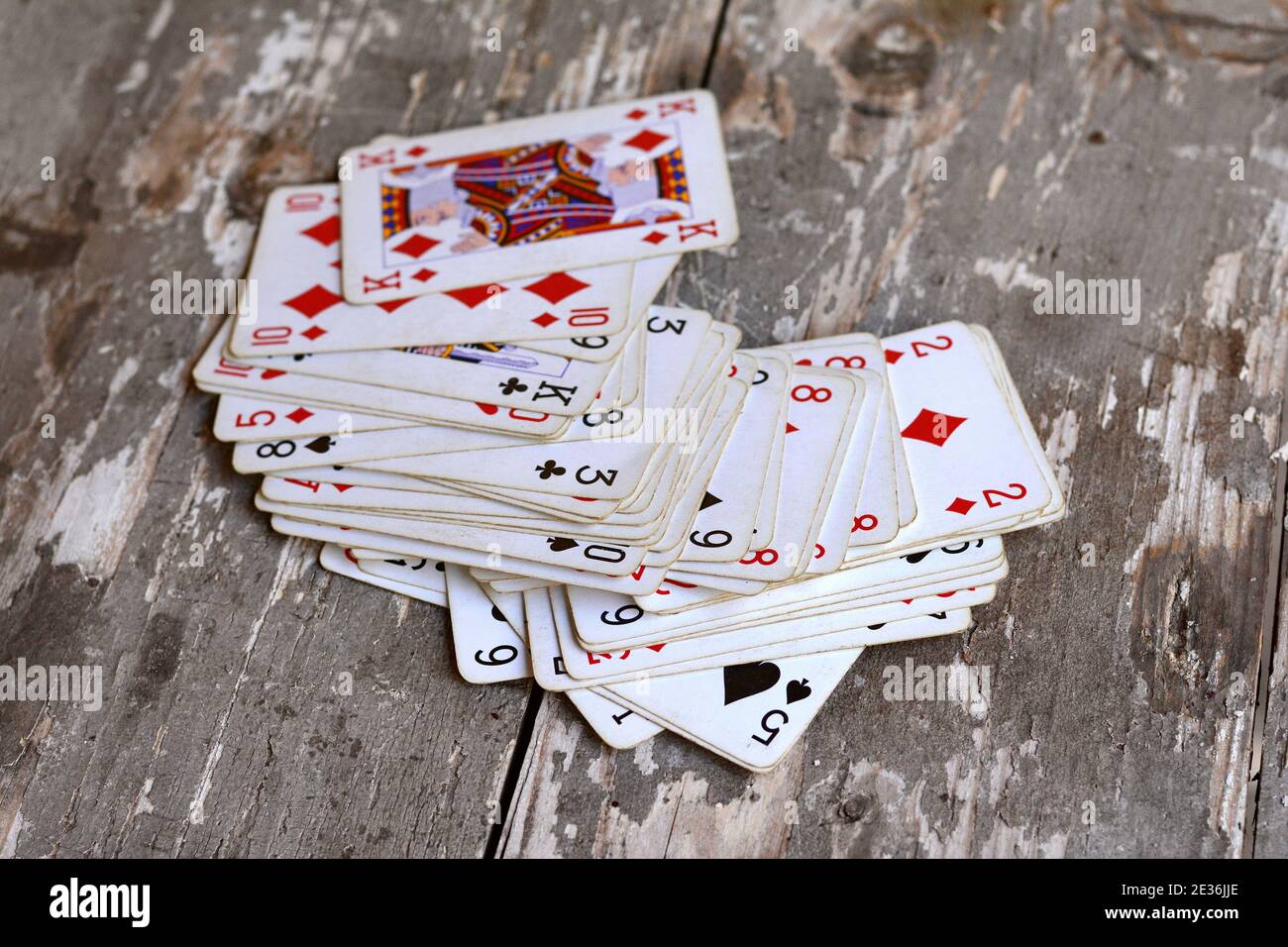 Pile of playing cards at a rustic wooden board Stock Photo - Alamy