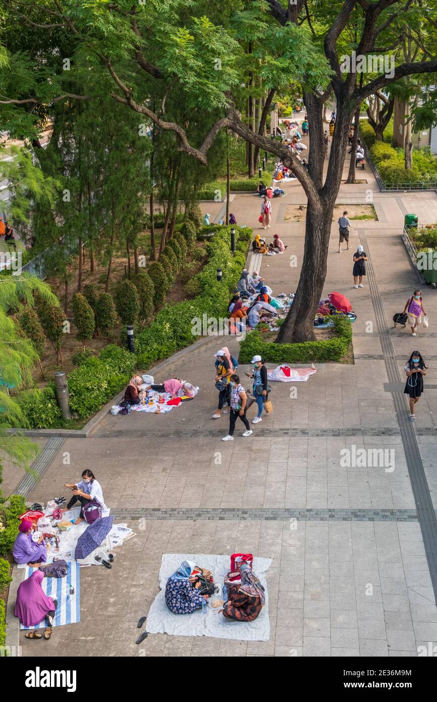 Domestic workers spend their day off in front Victoria Park, Hong Kong ...