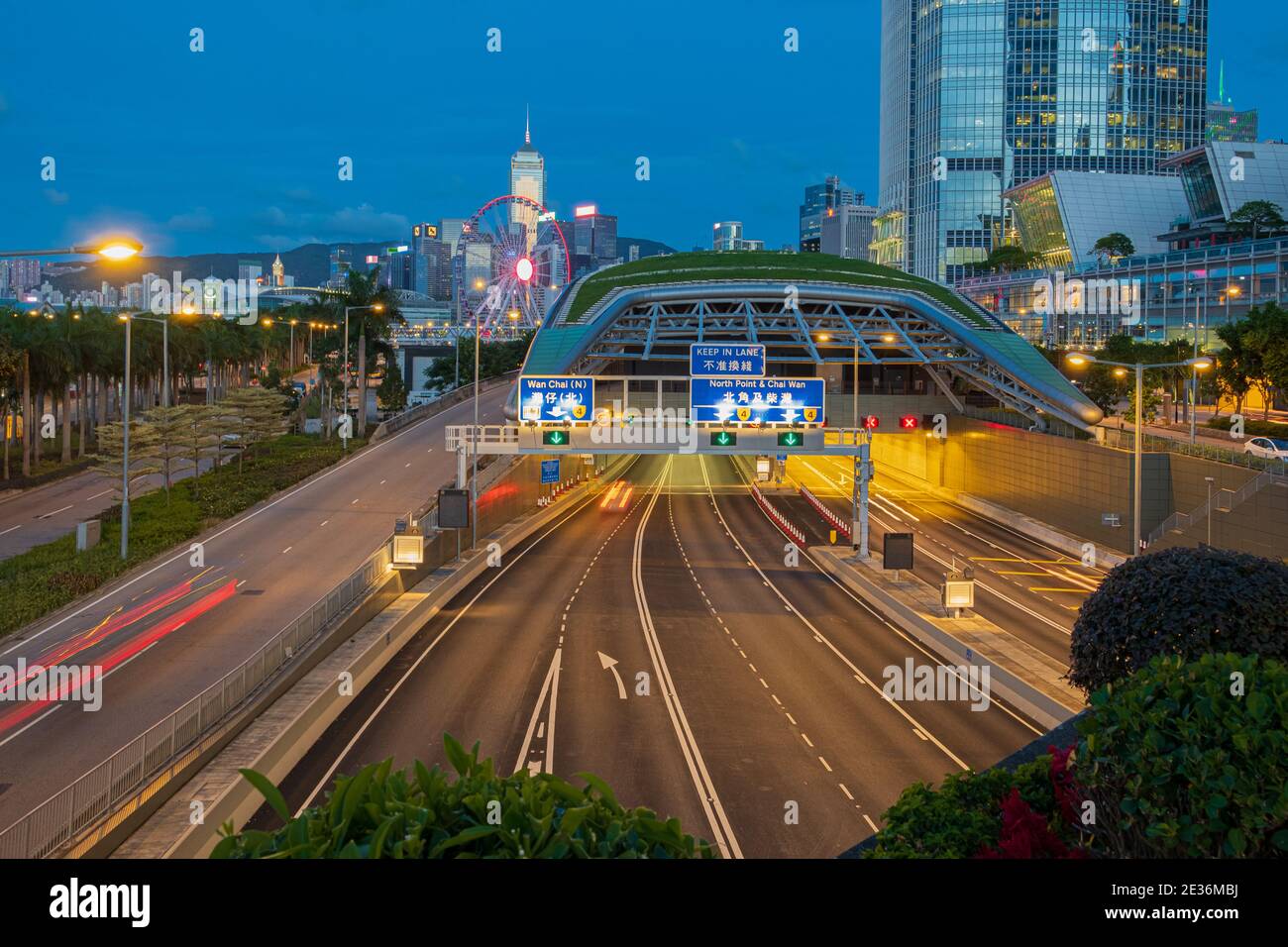 Urban highway to Wan Chai tunnel, framed by glowing skyscrapers and ...