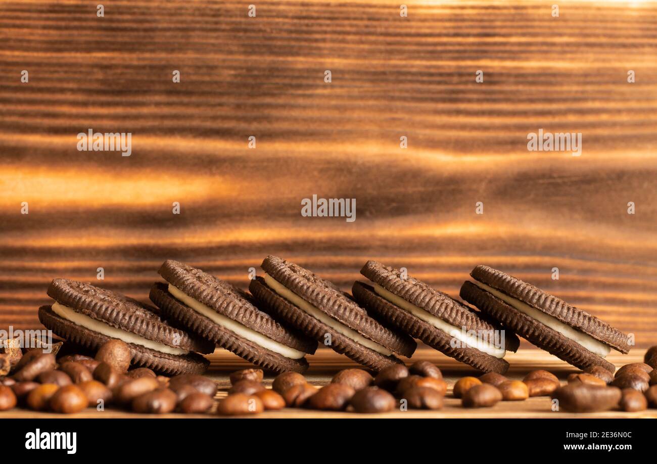 Cookies on a brown background of a burnt tree with coffee grains ...