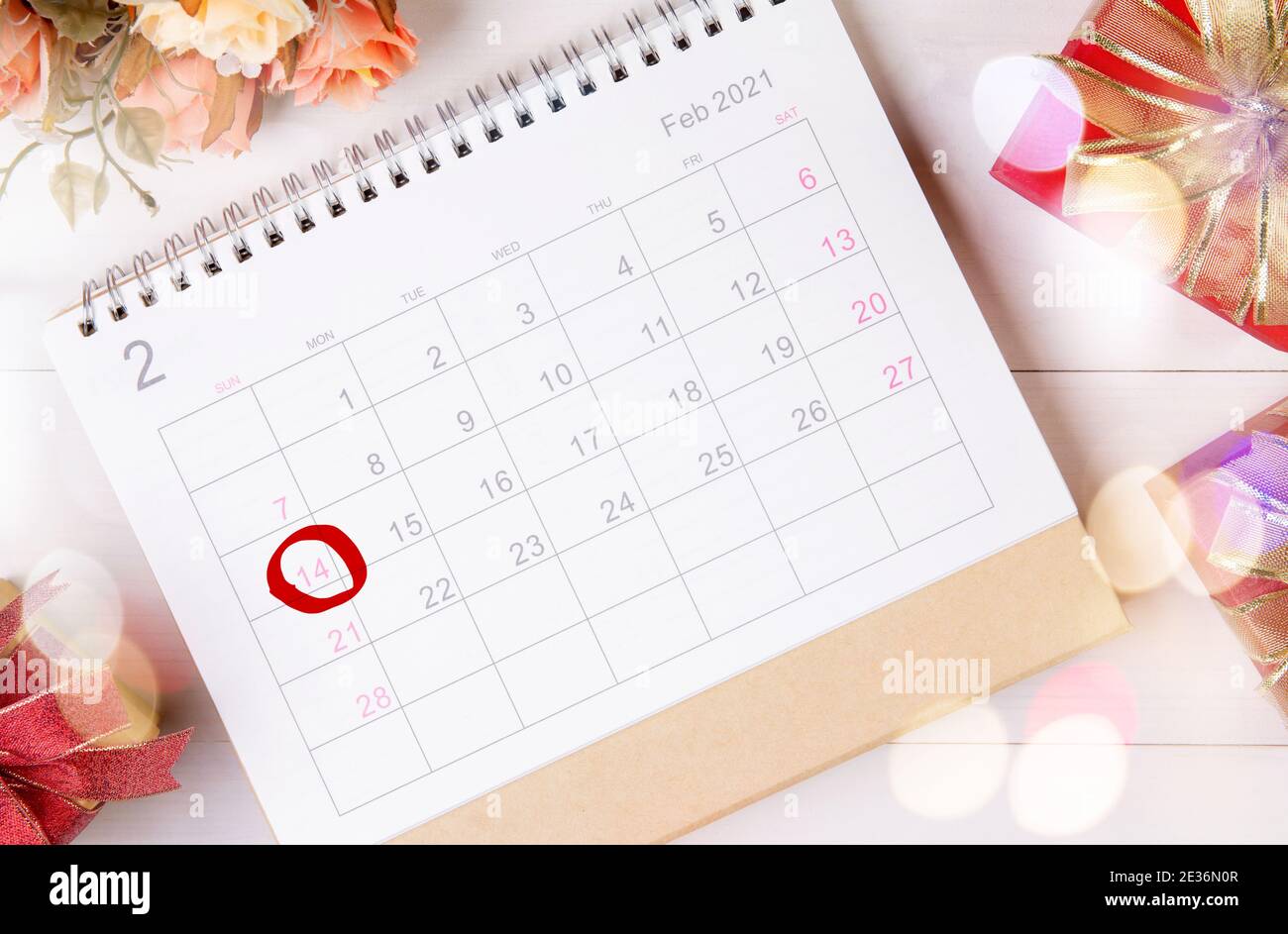 Calendar and flower with memo 14 February Valentine day on desk with ...