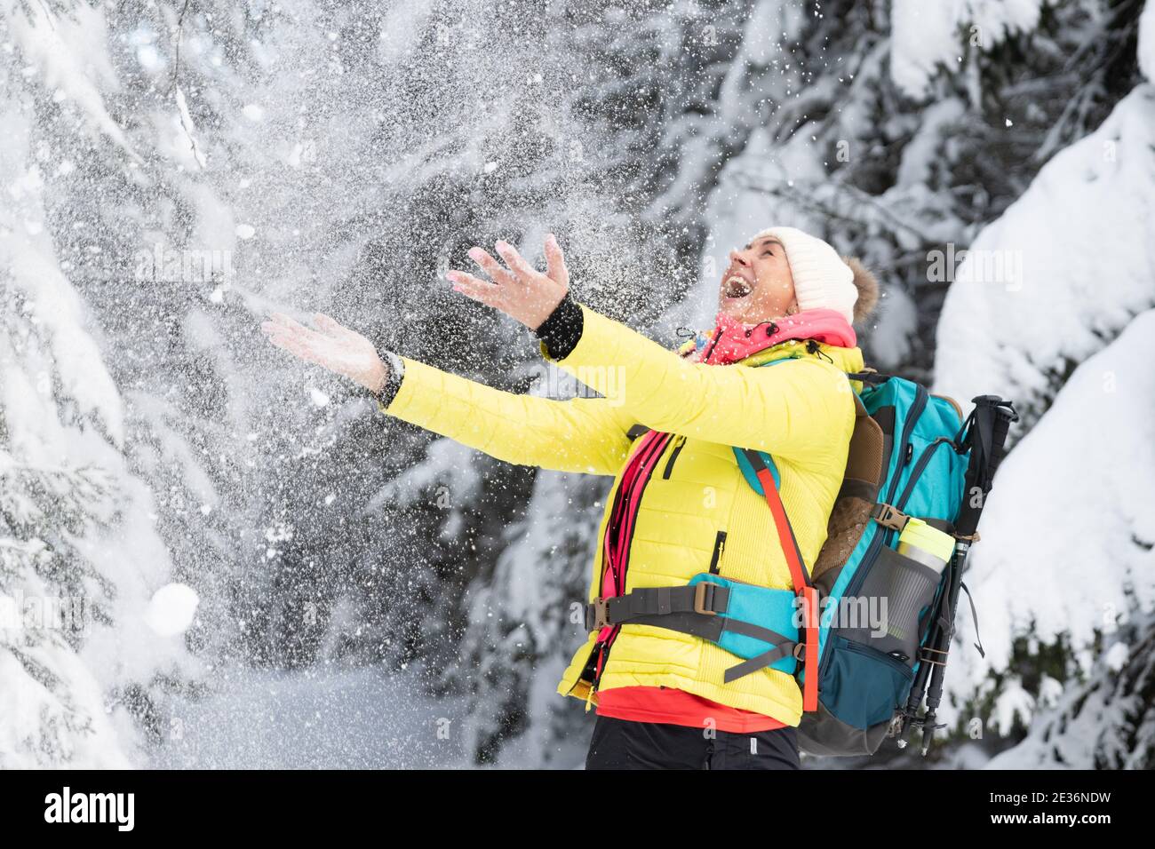 Happy, beautiful tourist is pouring snow. Beautiful winter scenery ...