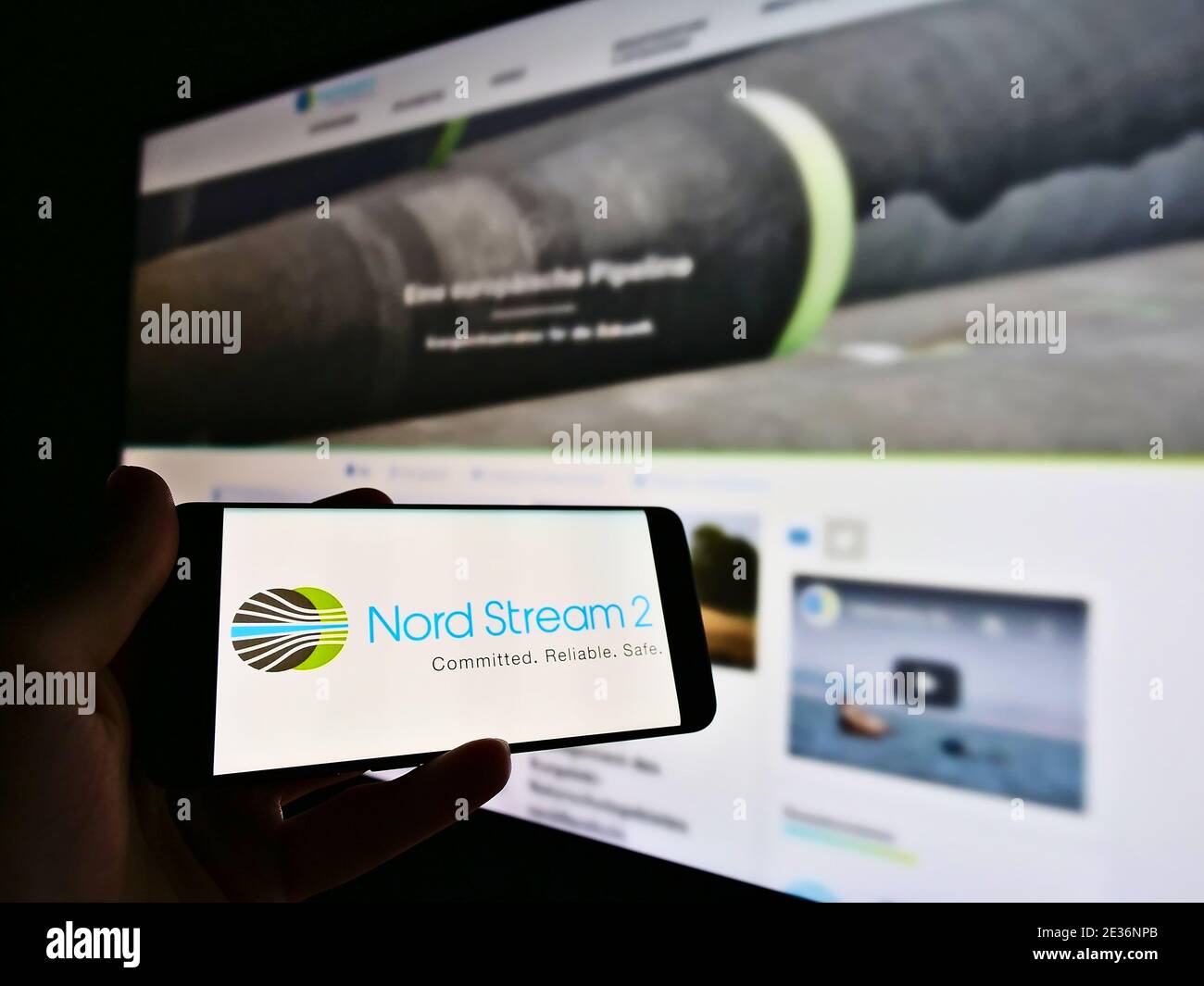 Person holding smartphone with logo of offshore natural gas pipeline ...