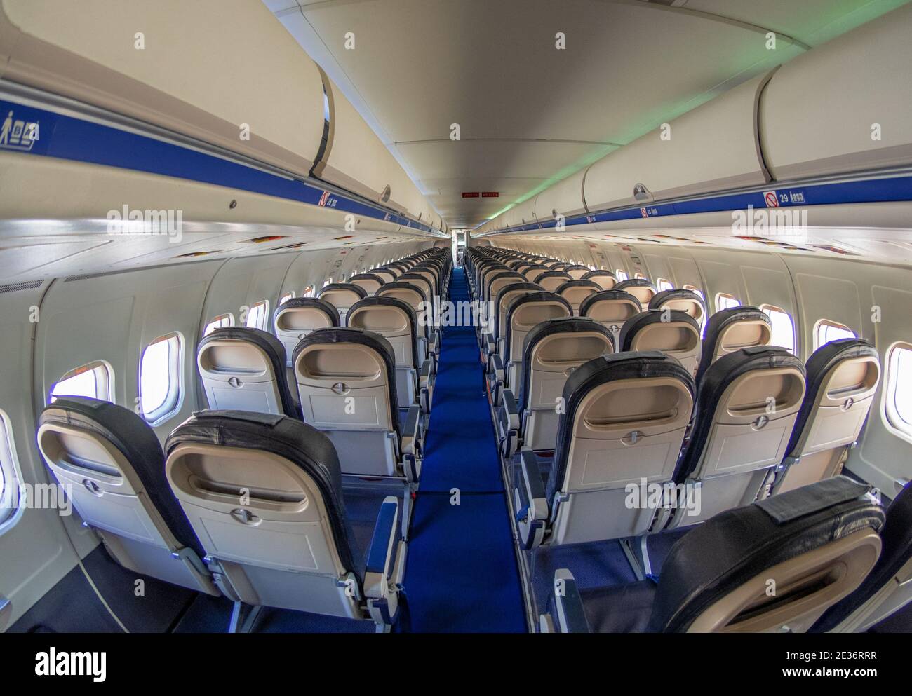 empty plane, passenger transport cabin, long blue corridor with ...
