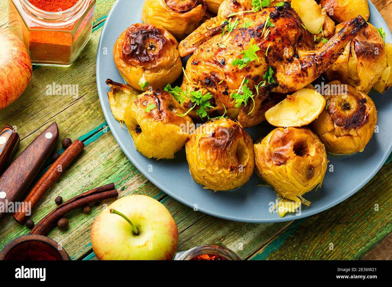 Homemade whole chicken or partridge baked with apples on a plate Stock ...