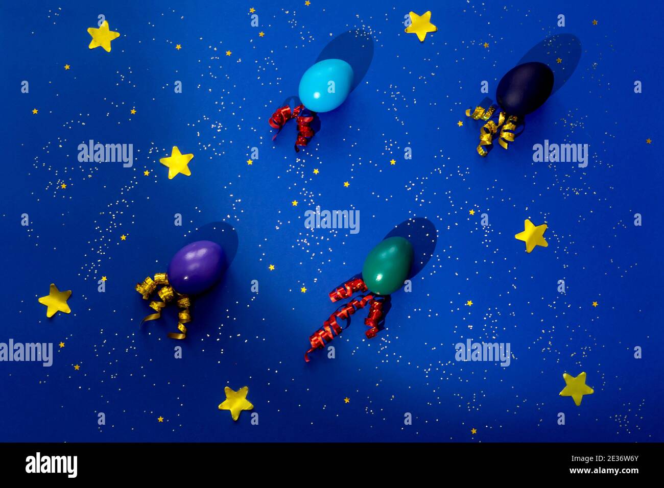 Color easter eggs as rockets over blue background. Easter festive ...