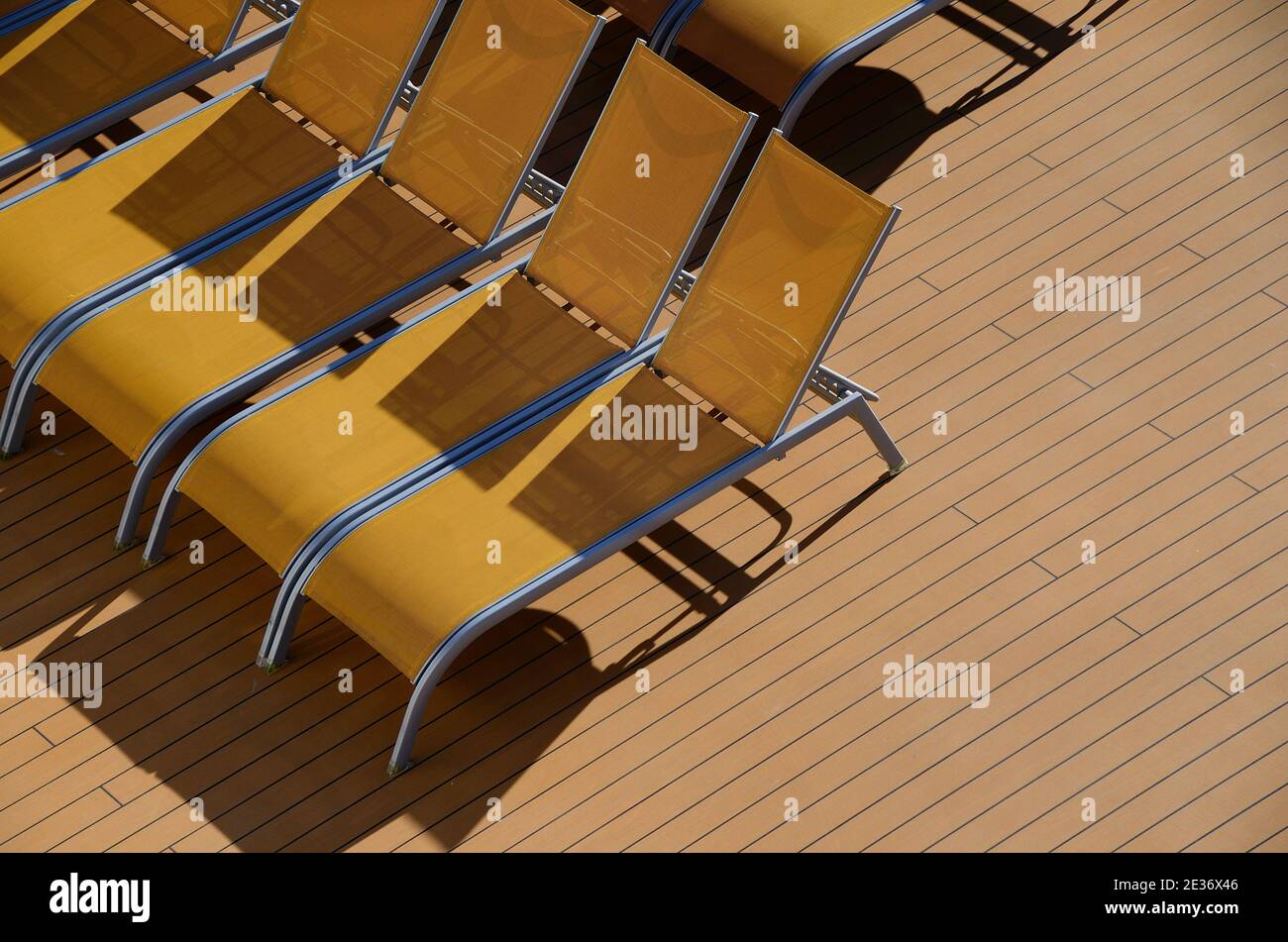 yellow sun loungers on a large cruise ship Stock Photo - Alamy