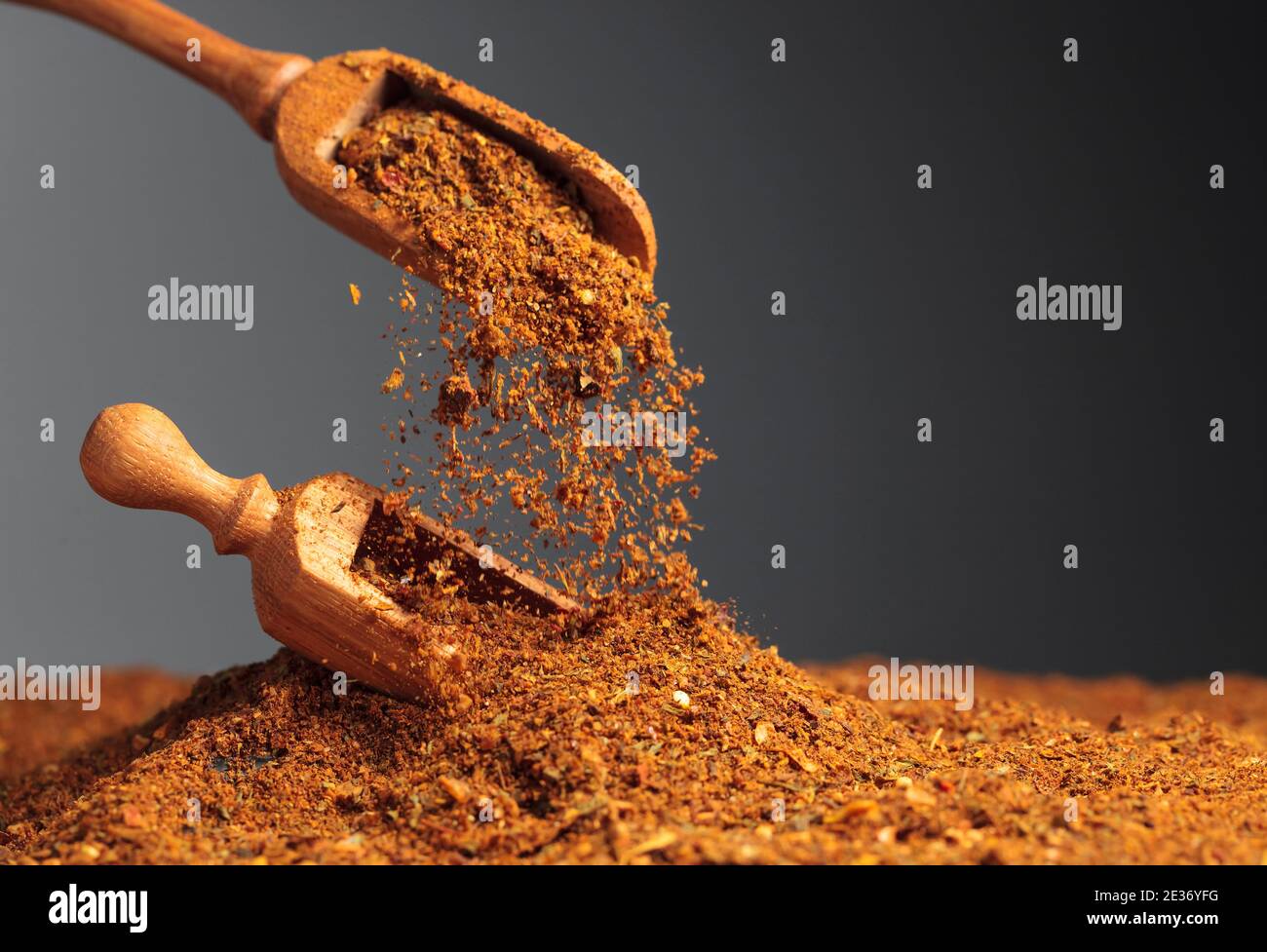 Oriental spices. Mixtures of various spices are poured with a wooden ...