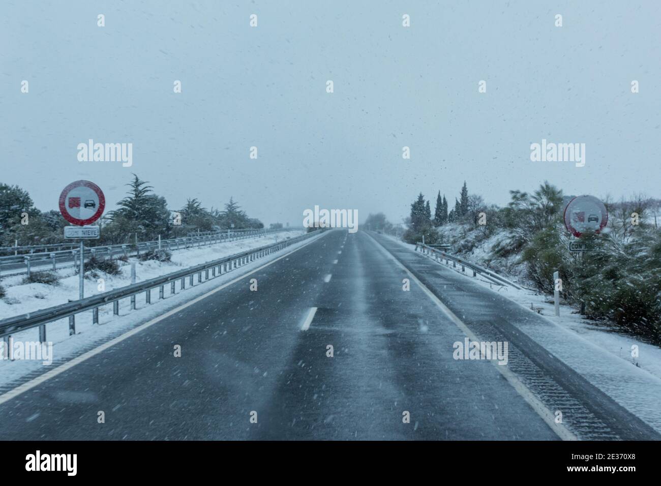 Vertical traffic signs forbidden to overtake trucks with snow on a day ...