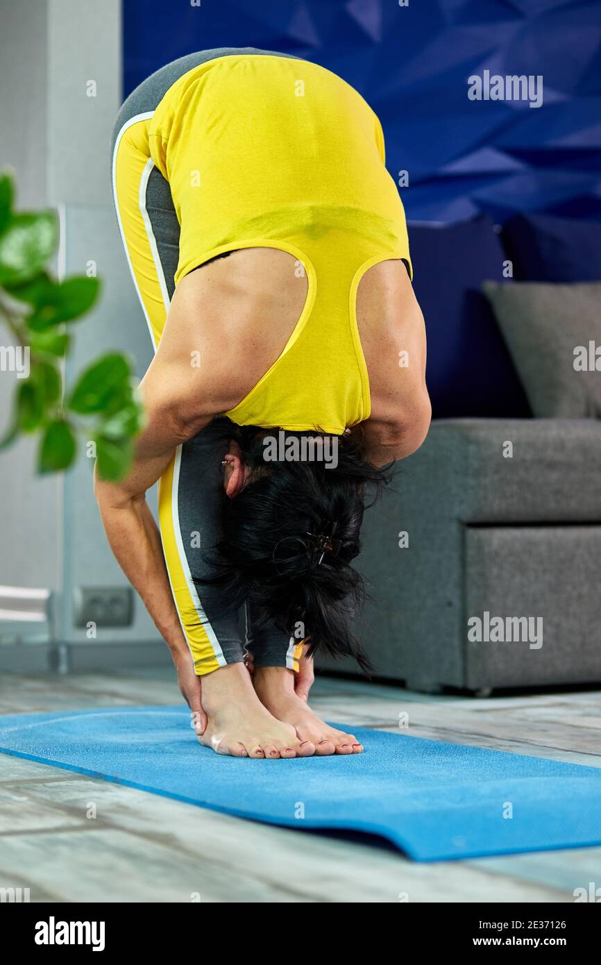 Senior woman stretching her body doing flexibility exercises and ...