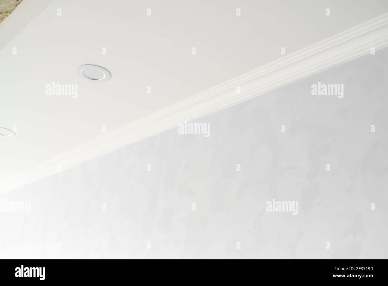 White ceiling with a white plinth in a room with gray painted walls ...