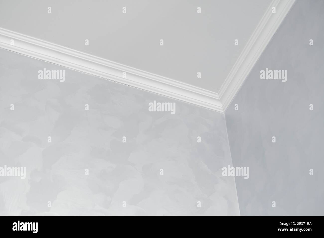 White ceiling with a white plinth in a room with gray painted walls ...