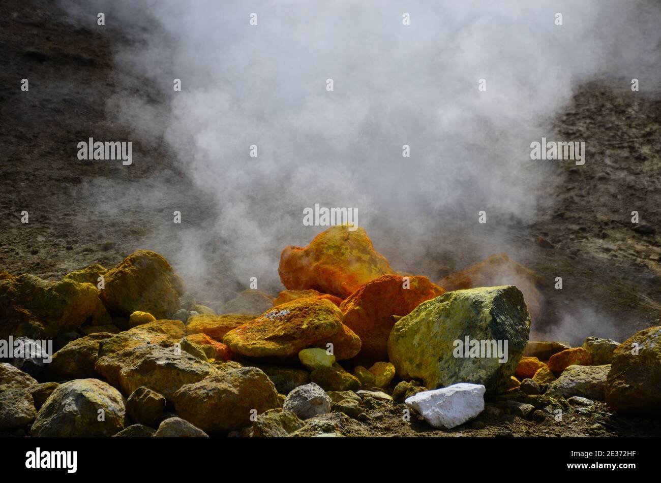 stones with sulfur and smoke in a volcanic crater Stock Photo - Alamy