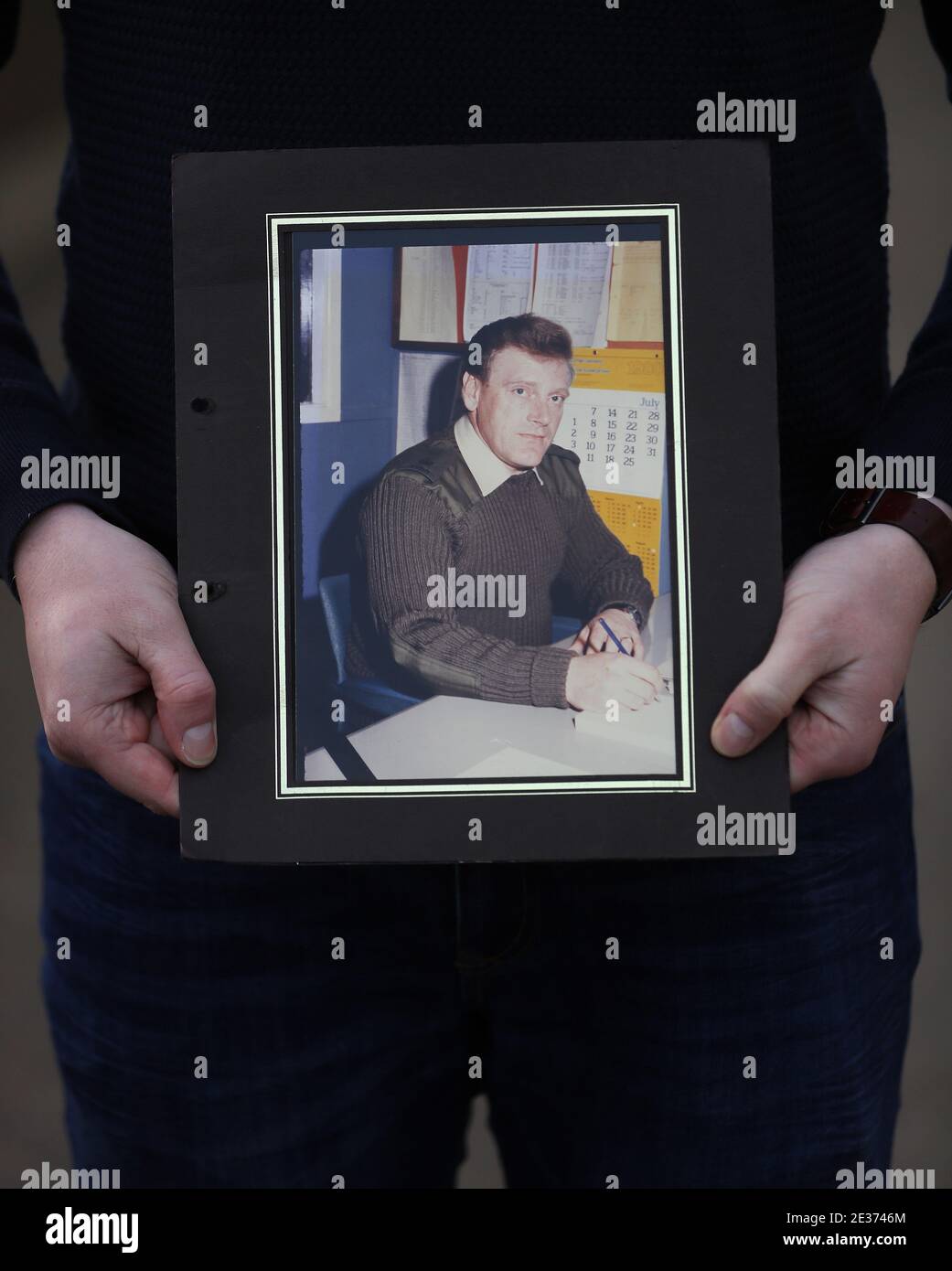 A photograph of Ivan Toombs is held by his grandson Ivan. The family of ...
