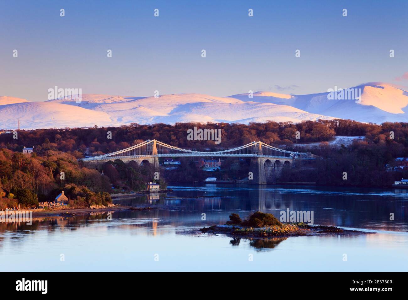 Scenic view to snowy Snowdonia mountains across Menai Strait with Menai ...