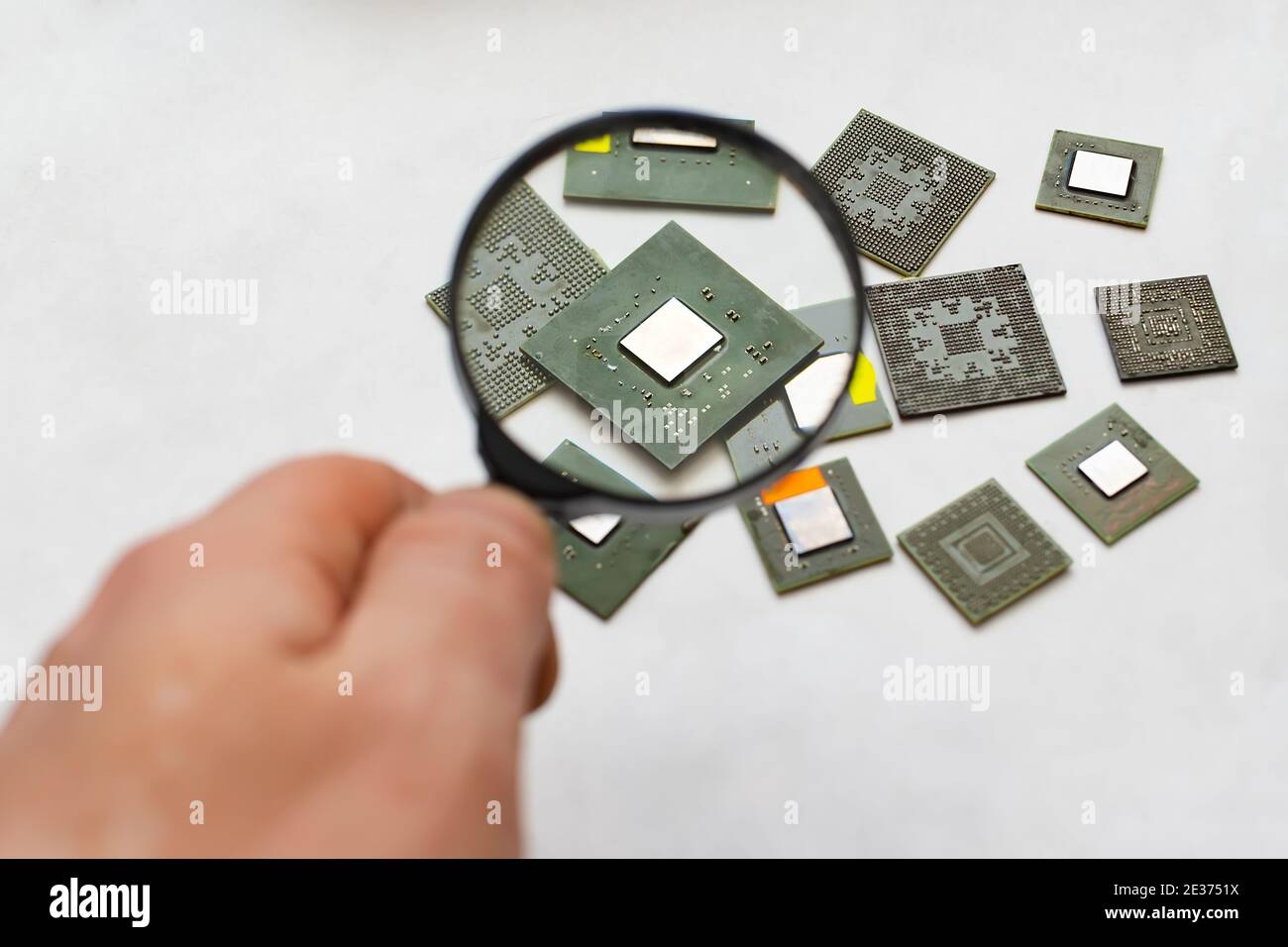 computer chip, a microprocessor that a person views through a ...