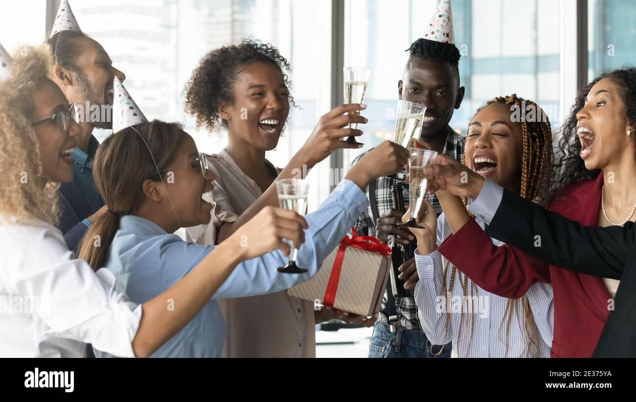 Overjoyed diverse colleagues celebrate in office together Stock Photo ... Overjoyed diverse colleagues celebrate in office together Stock Photo ...