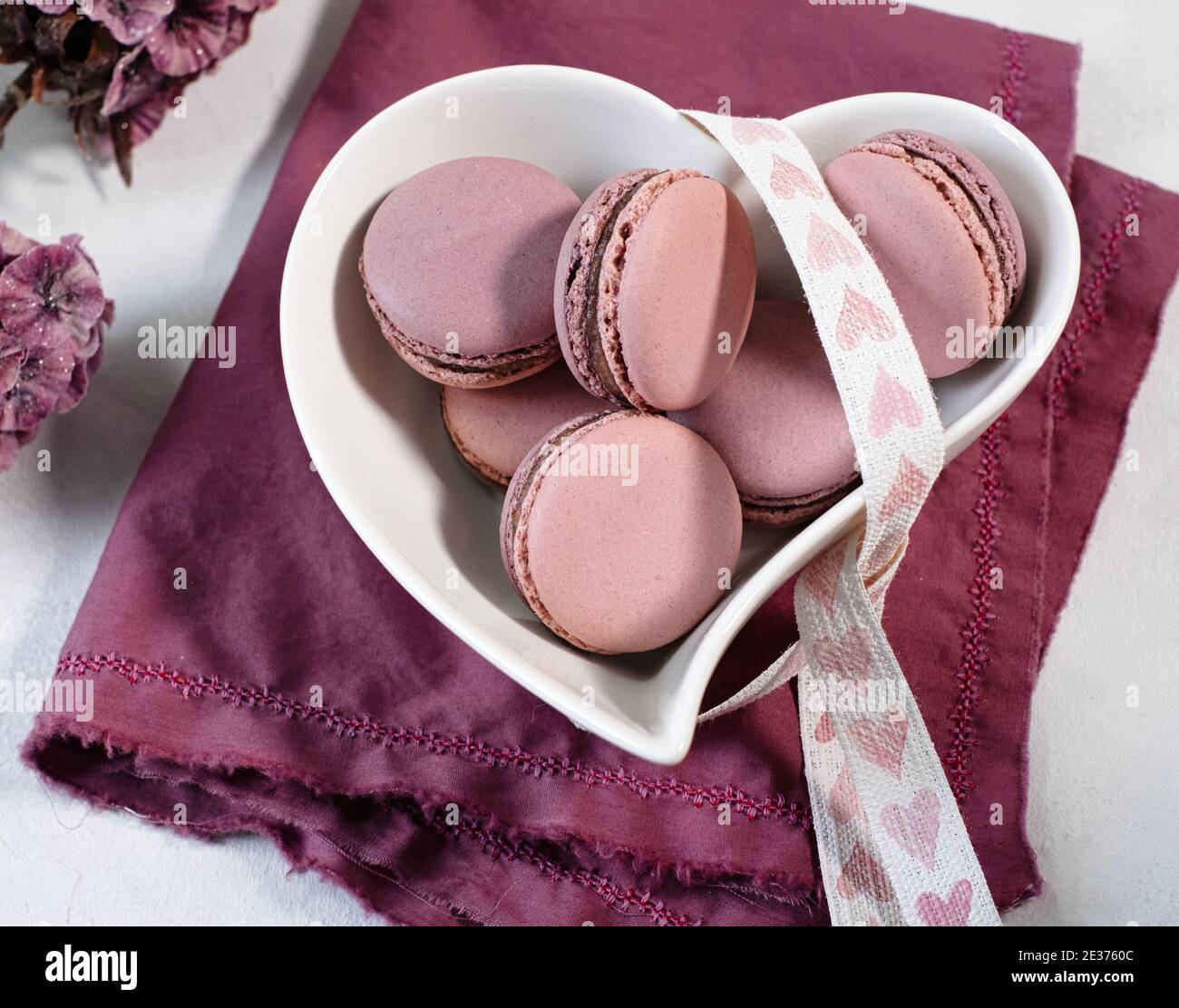 Fig macarons on a white concrete background with plum blue napkin and a ...