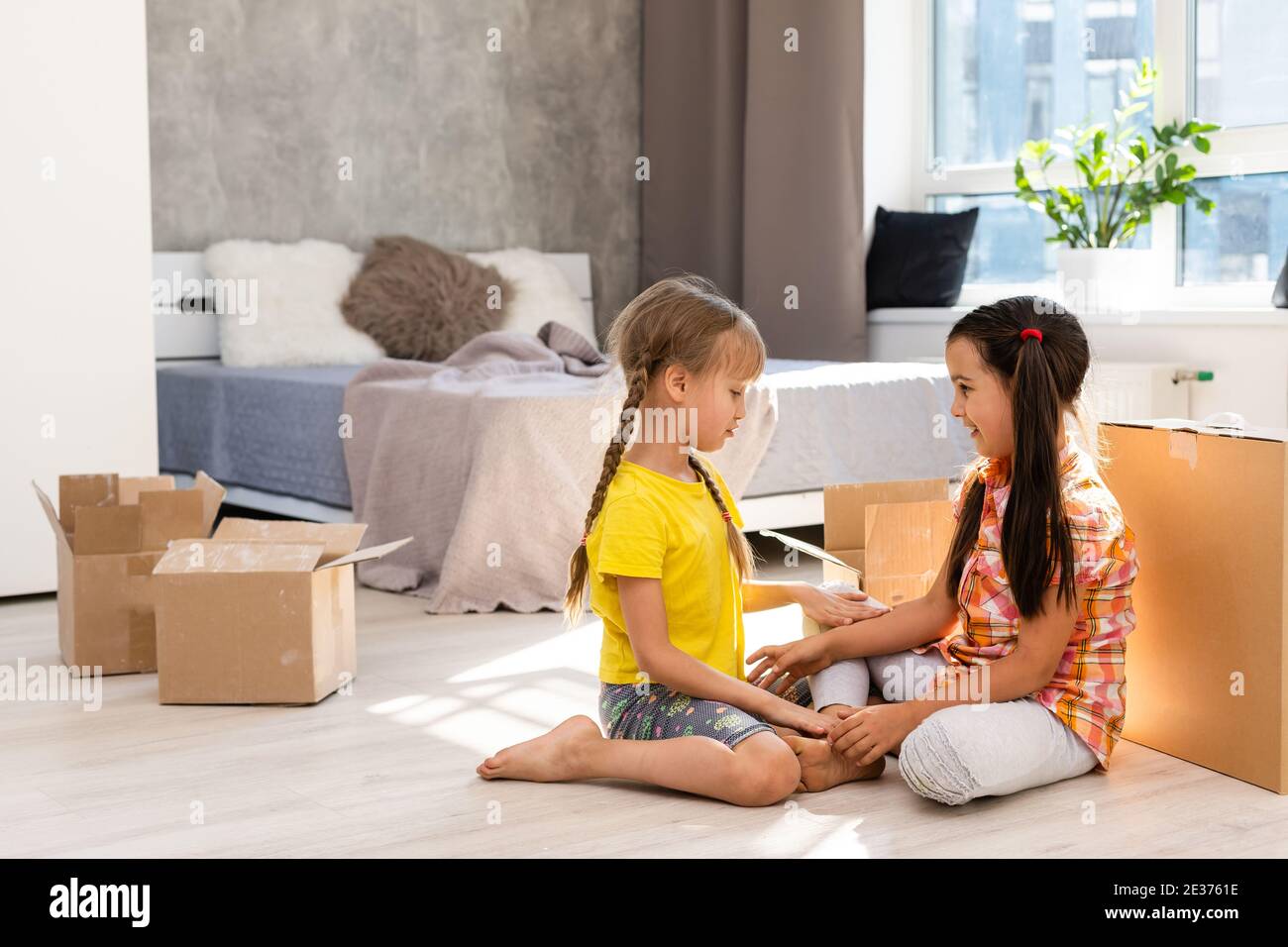 Excited funny kids girls running inside luxury big modern house on ...