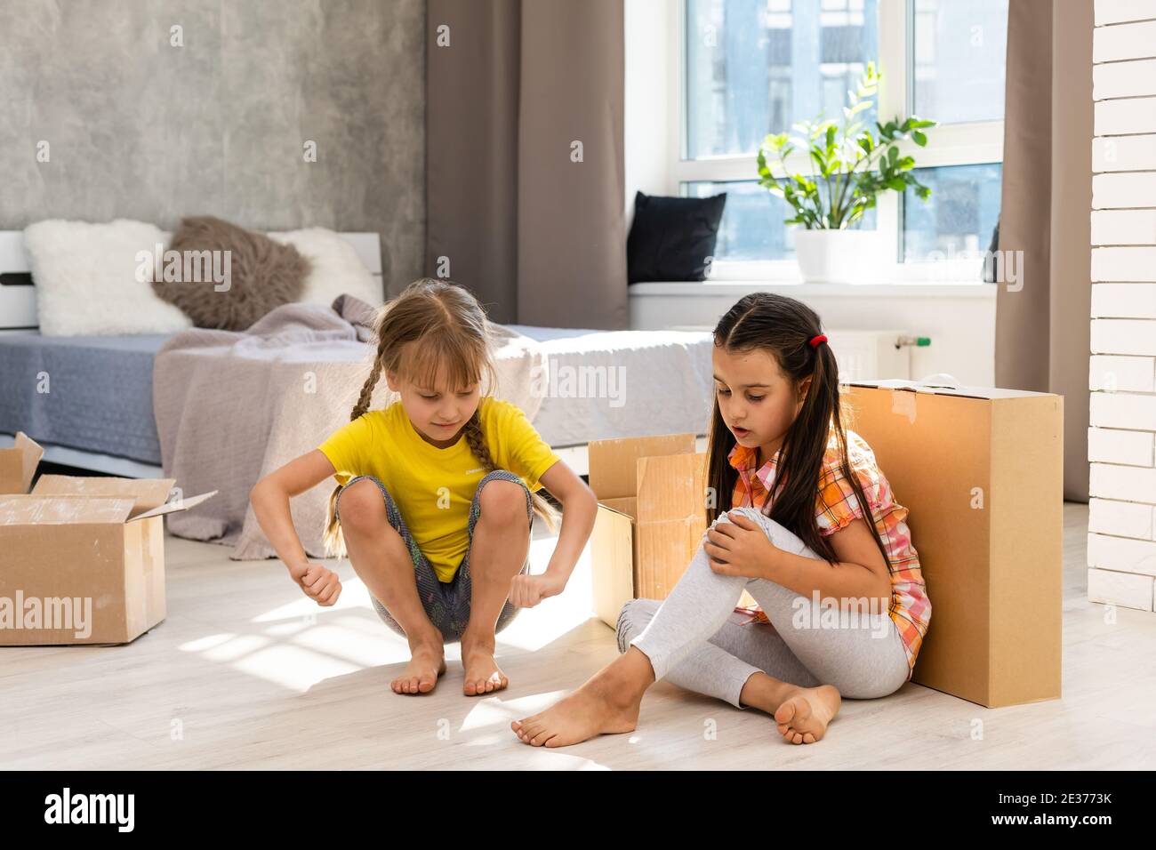 Excited funny kids girls running inside luxury big modern house on ...