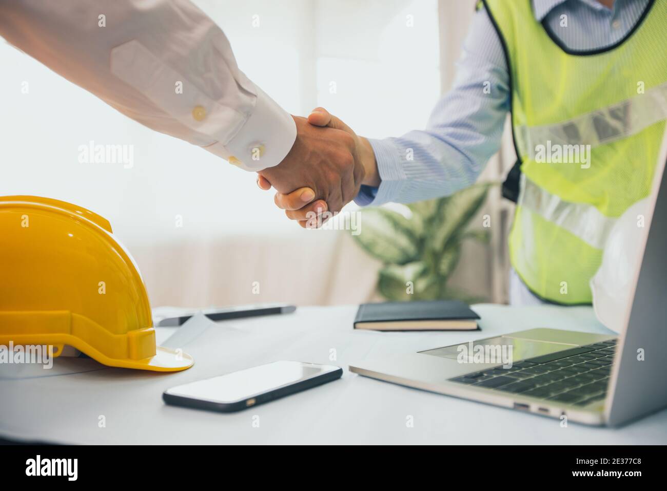 Handshake of builder, engineer with architecture after successful ...