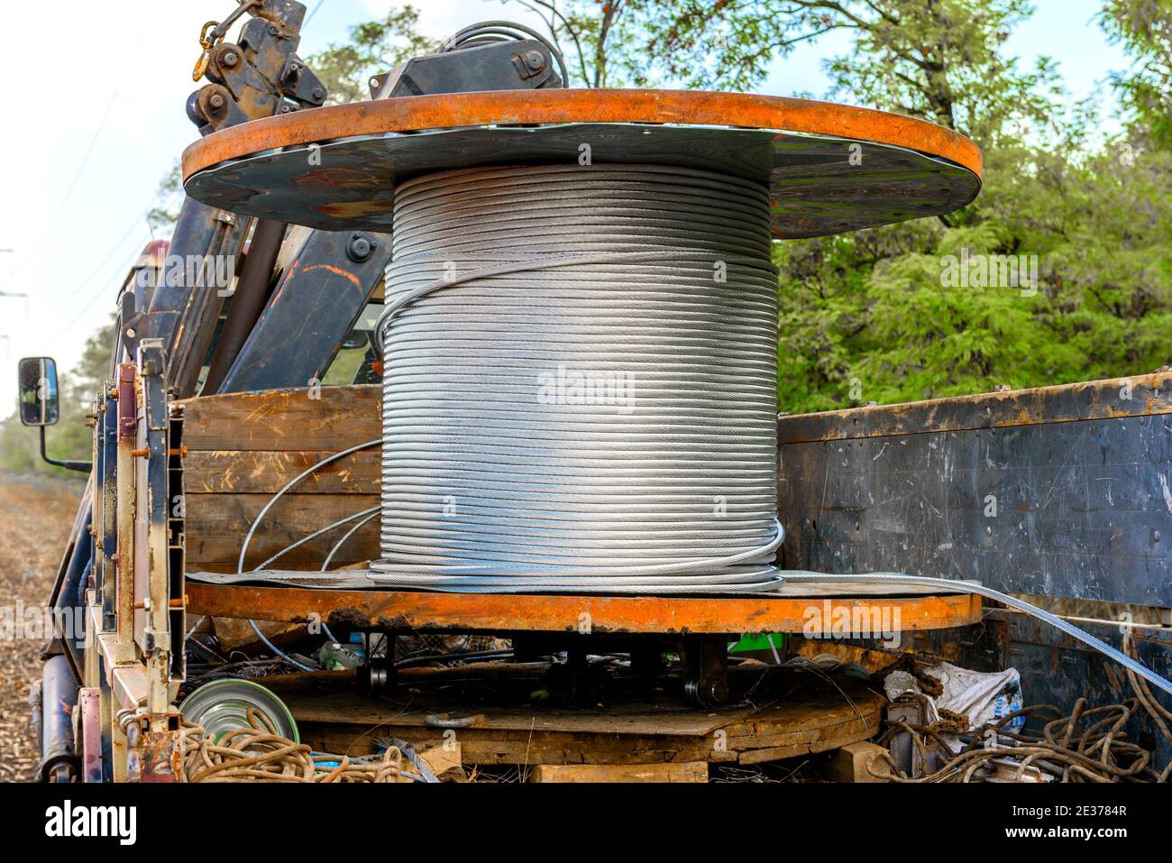 Coil with high-voltage cable mounted on wheeled truck. Installation of ...