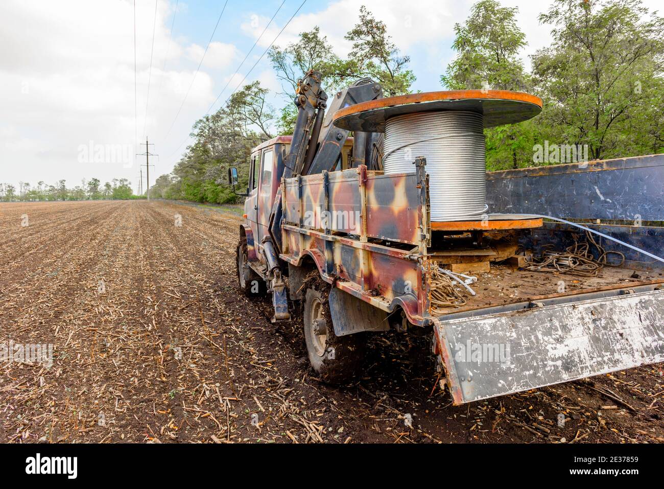 Coil with high-voltage cable mounted on wheeled truck. Installation of ...