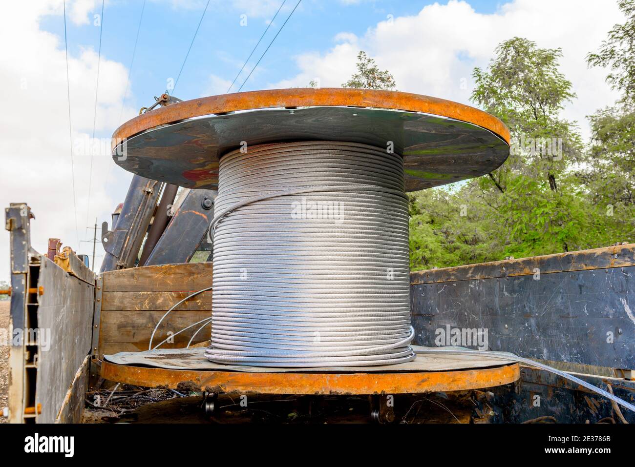Coil with high-voltage cable mounted on wheeled truck. Installation of ...